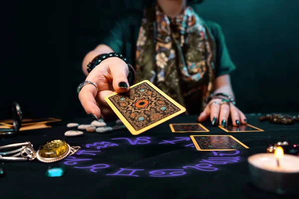 Fortune-telling on cards. The fortune teller hands over a Tarot card ...