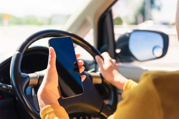 Asian woman inside a car and using a hand holding mobile smartphone ...