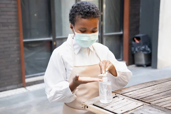 Black African Woman Employee Shop Keeper Holding Alcohol Gel Dispenser ...