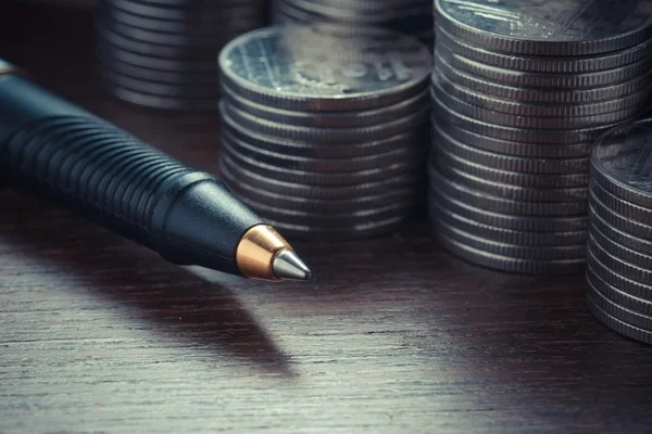 Money concept coins and pen with filter effect retro vintage sty ...