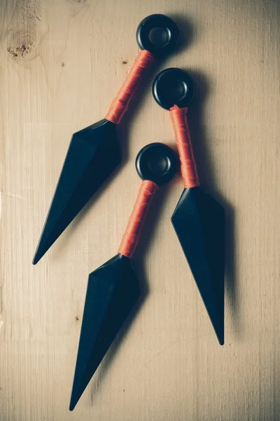 To throw ninja weapons isolated on blue paper background — Stock Photo ...