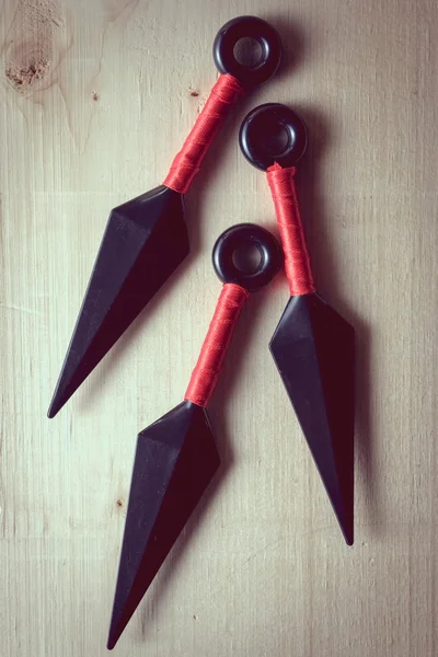 To throw ninja weapons isolated on blue paper background — Stock Photo ...