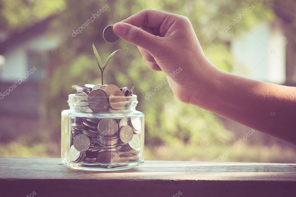 Hand putting money coins with filter effect retro vintage style Stock ...