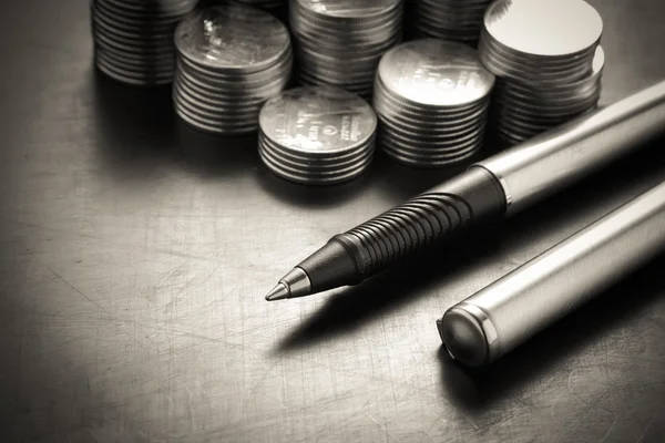 Money concept coins and pen with filter effect retro vintage sty ...