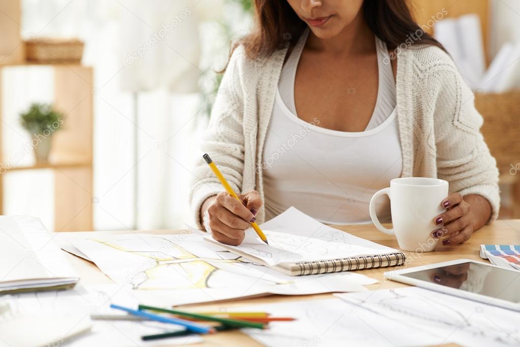 Designer drawing sketches Stock Photo by ©DragonImages 108430120