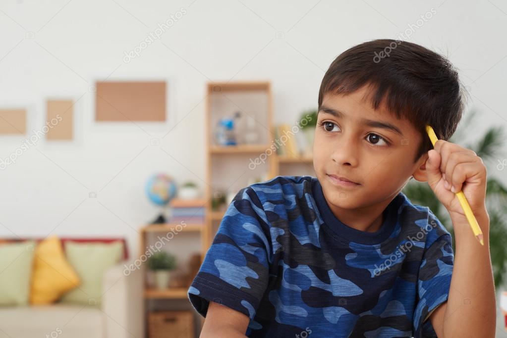 Indian boy thinking over ideas — Stock Photo © DragonImages #116372638