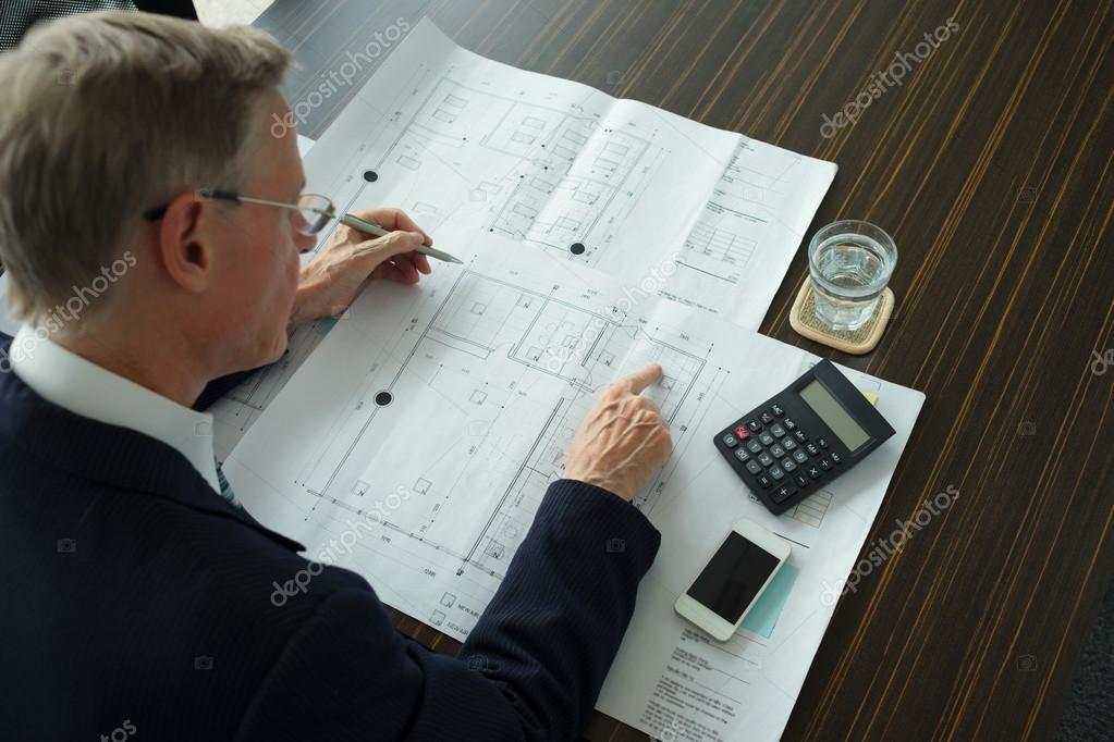 Engineer calculating the cost Stock Photo by ©DragonImages 67319119