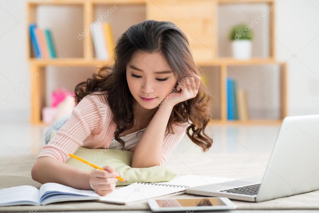 College student doing homework — Stock Photo © DragonImages #82479512