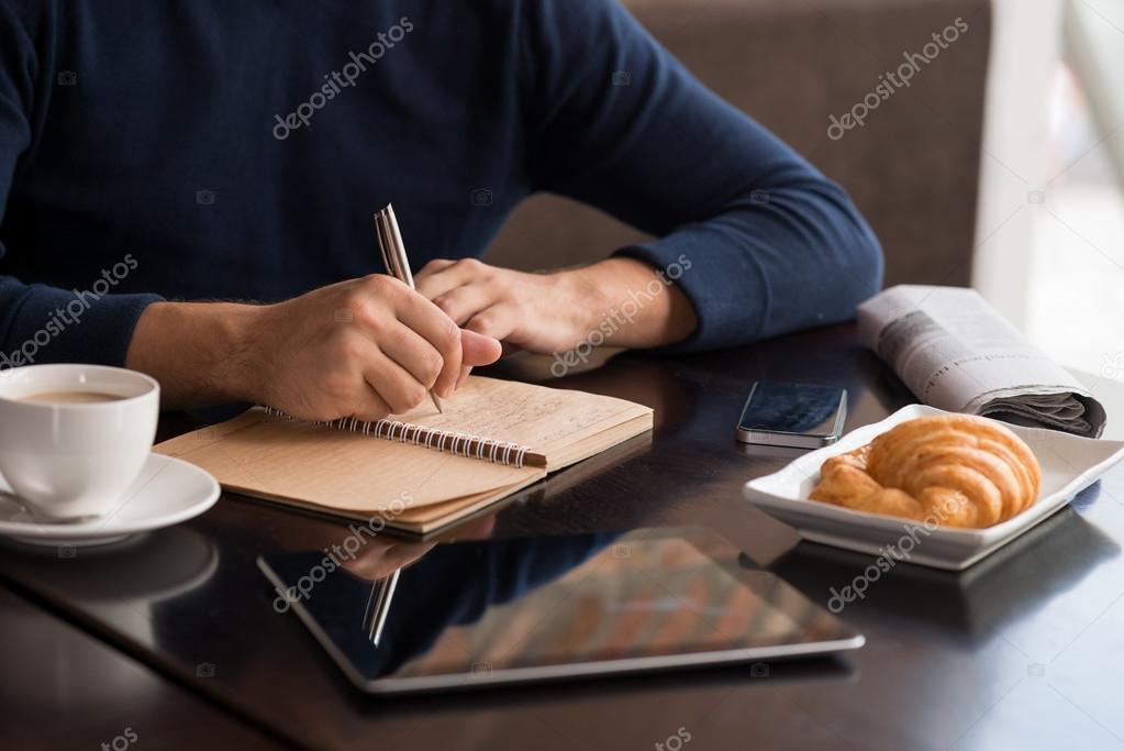Man writing down thoughts — Stock Photo © DragonImages #85774210