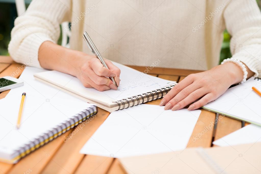 Woman making notes in her notepad — Stock Photo © DragonImages #85881310