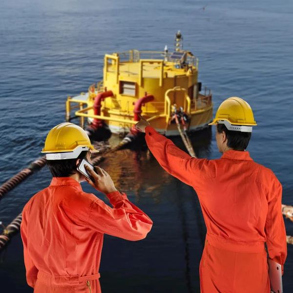Oil worker and oil rig. montage concept — Stock Photo © kampee_p #74659099
