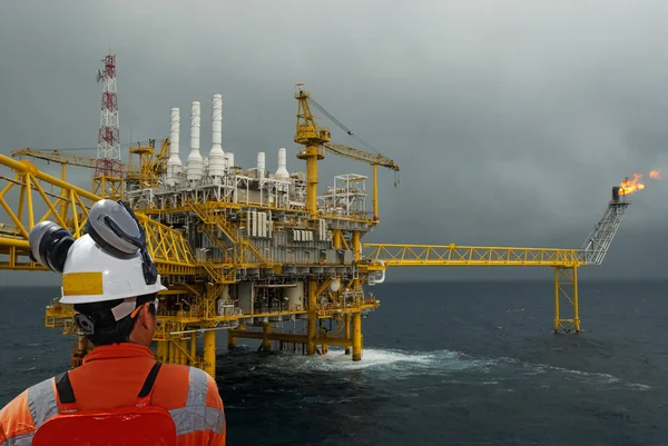 Oil worker and oil rig - Stock Image - Everypixel