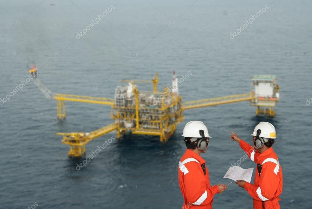 Oil worker and oil rig. montage concept — Stock Photo © kampee_p #74659075