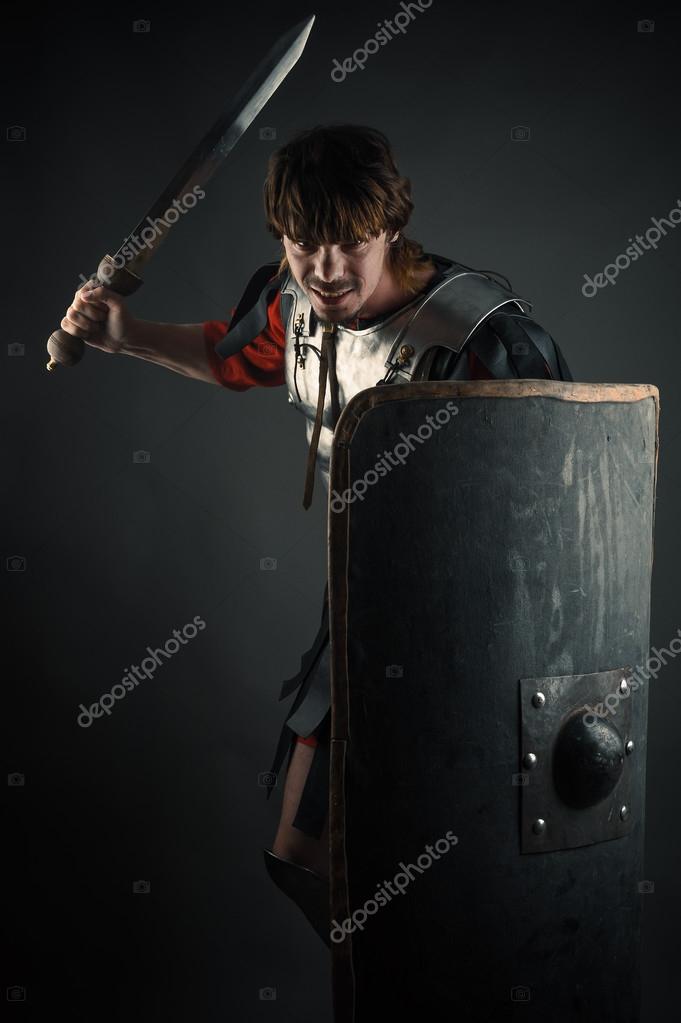 Young warrior with a sword and shield in hand — Stock Photo © Dualshock ...