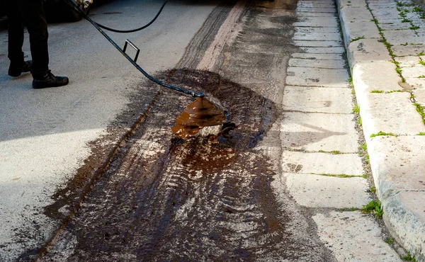 Spraying bitumen emulsion Pictures, Spraying bitumen emulsion Stock ...