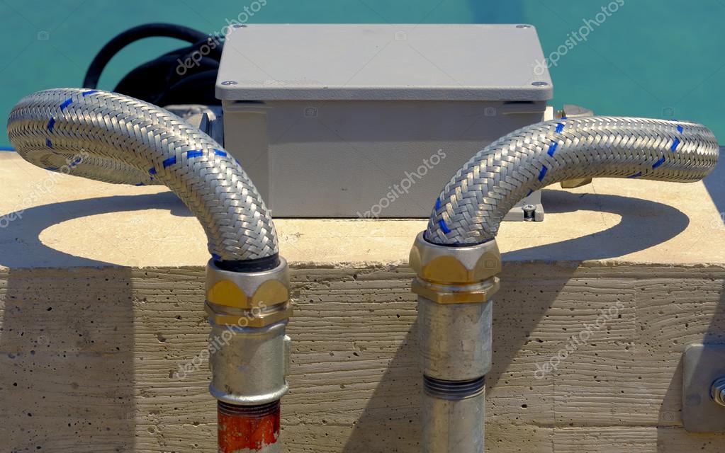Galvanized steel tubes mounted on a concrete wall — Stock Photo © Ba ...