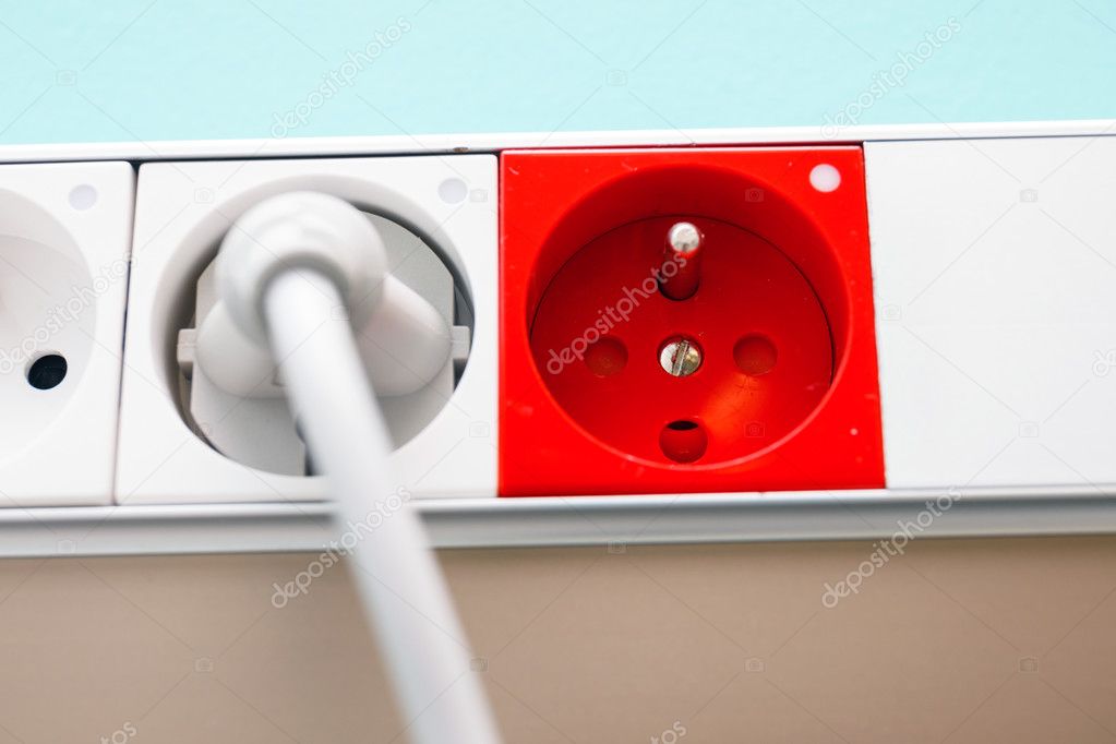 Electric plug in a socket Stock Photo by ©wujekspeed 64209563
