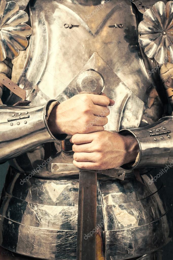 Knight wearing armor and holding sword — Stock Photo © merrydolla #52412173