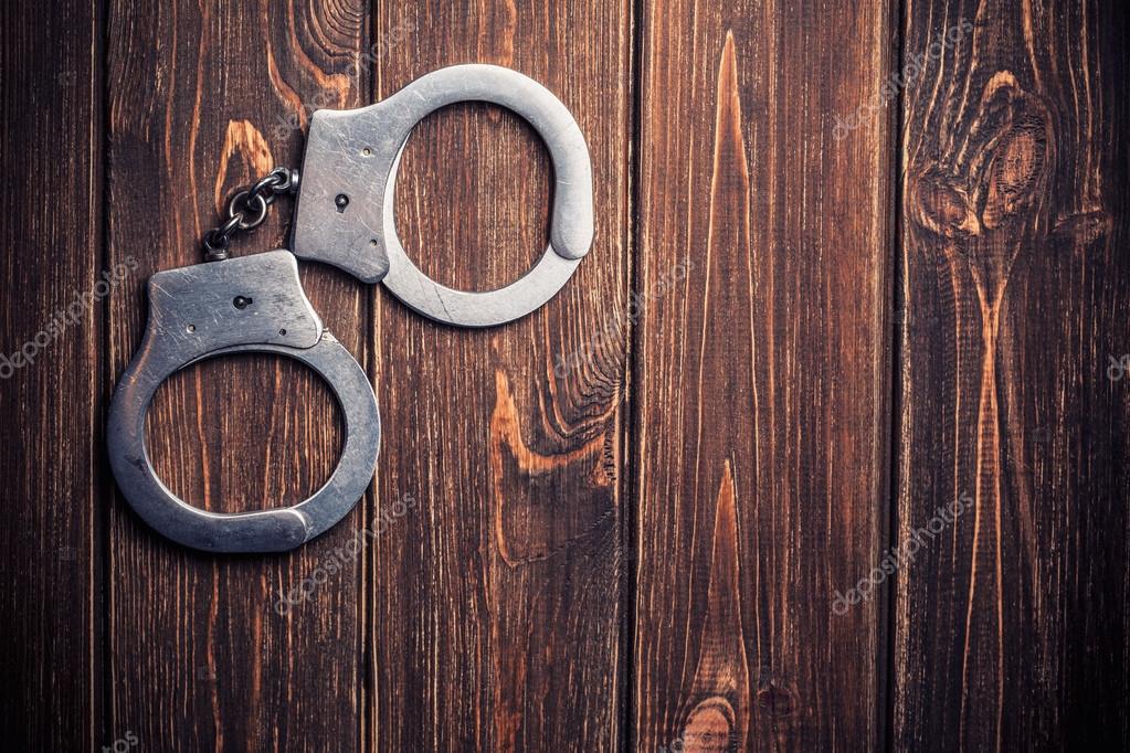 Police Handcuffs on table Stock Photo by ©merrydolla 59162669