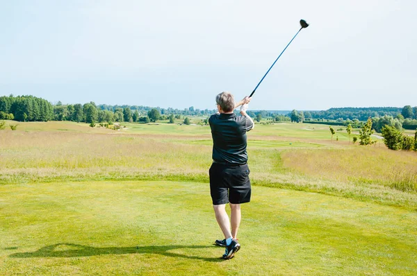 A sports man plays golf and kicks the ball on the golf course. - Stock ...