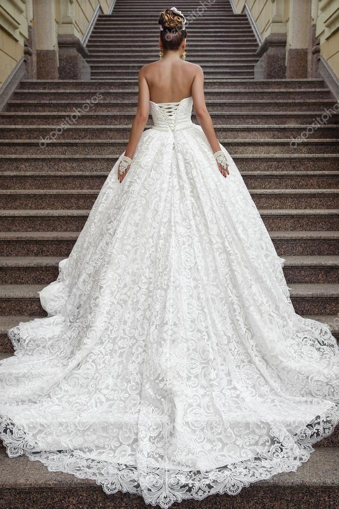 Back view of beautiful bride on stairs — Stock Photo © santiss #78557480