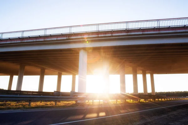 The highway is crossed by a bridge with a road against the backdrop of ...