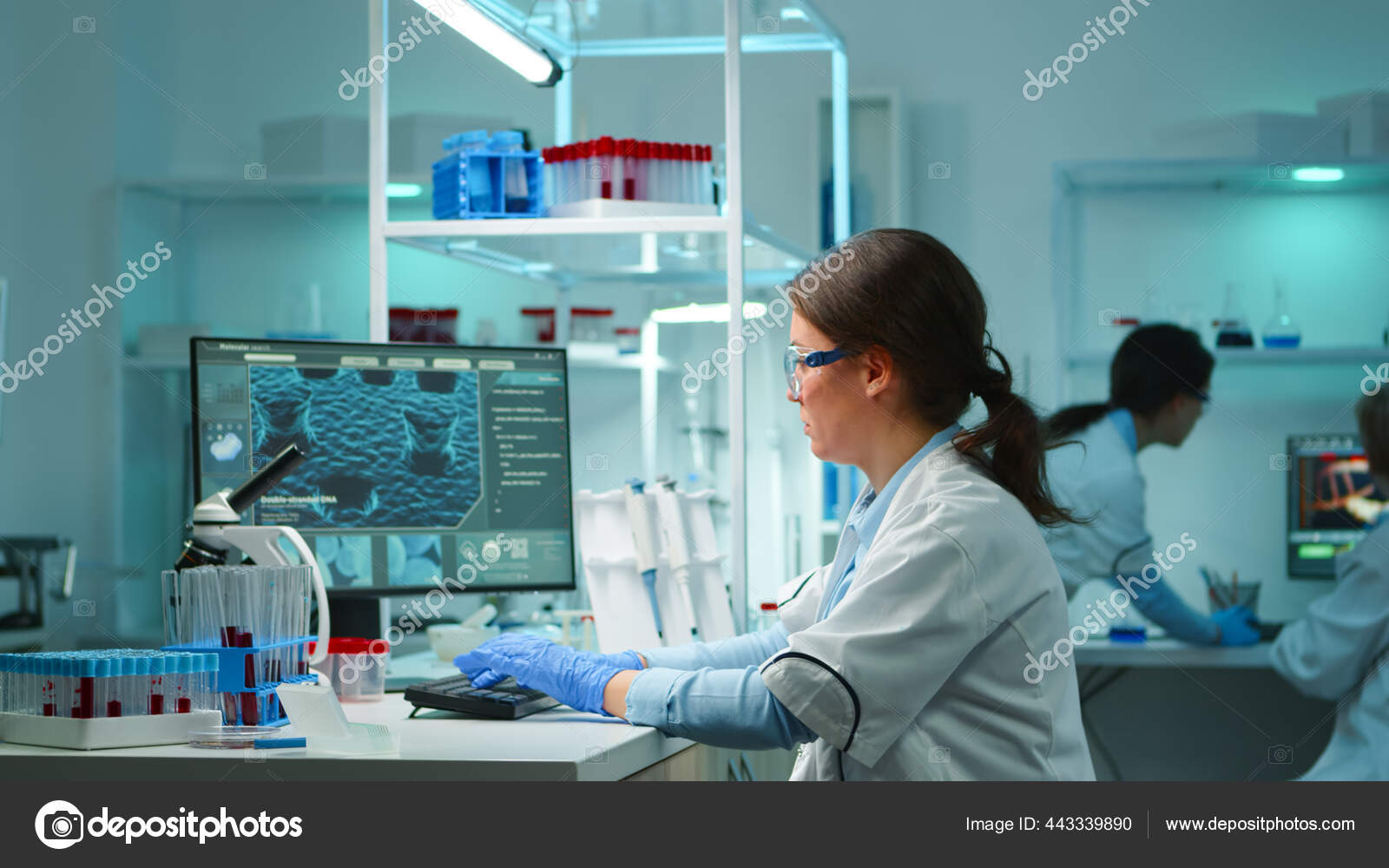 Scientist nurse typing on pc late at night working in laboratory ⬇ ...