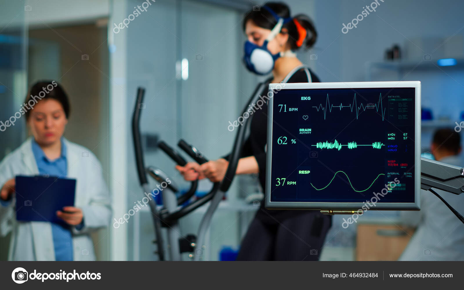 Monitor showing EKG scan of athlete running on cross trainer Stock ...