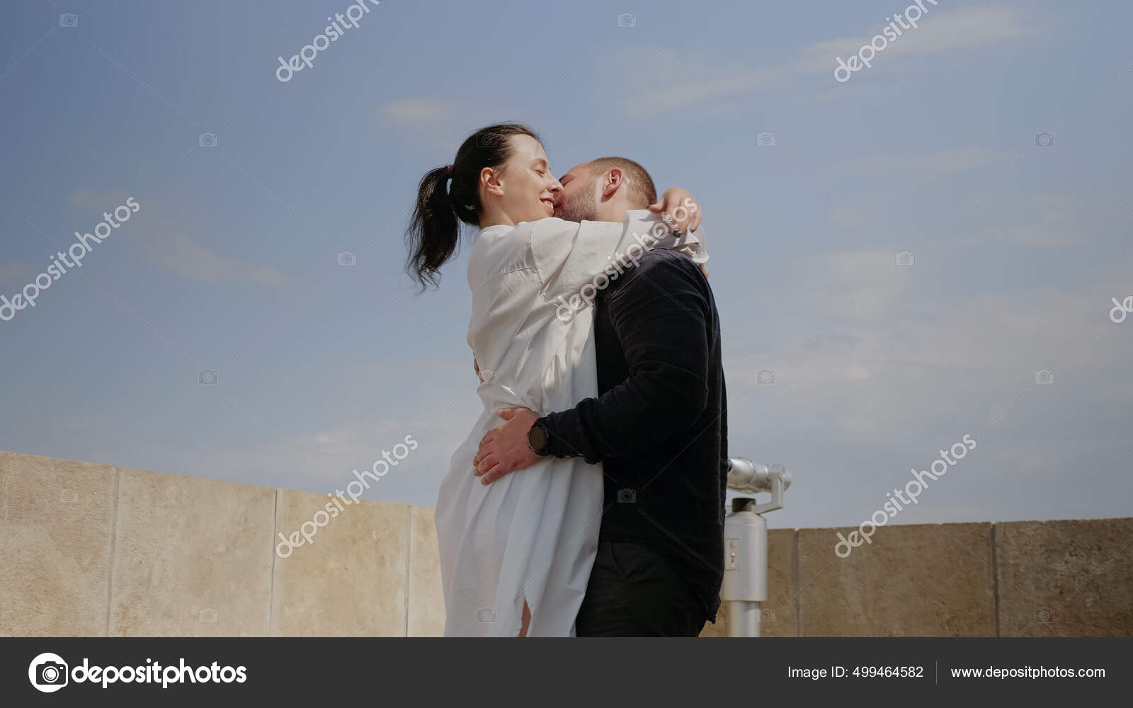 Young couple kissing on top of skyline tower above town — Stock Photo ...