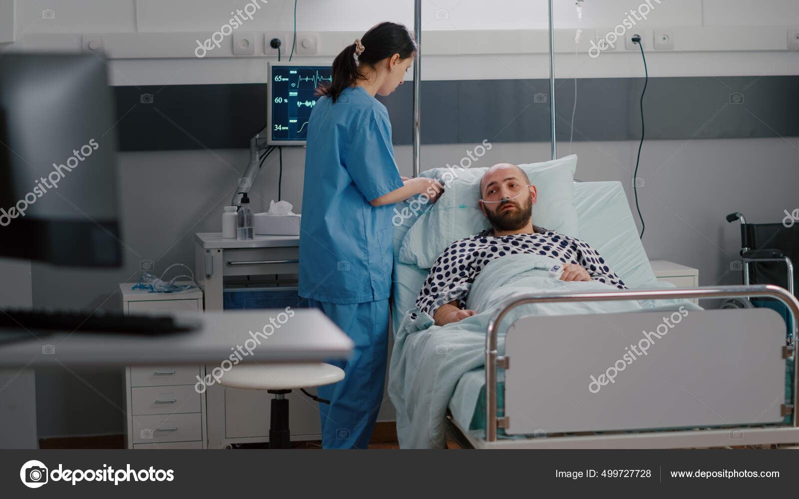 Practitioner asisstant arrange patient bed to sick man during sickness ...