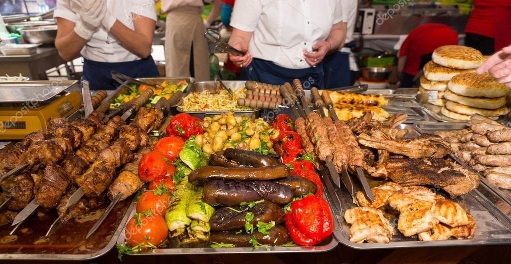 Customers Choosing Meat and Vegetables from Buffet Stock Photo by ...