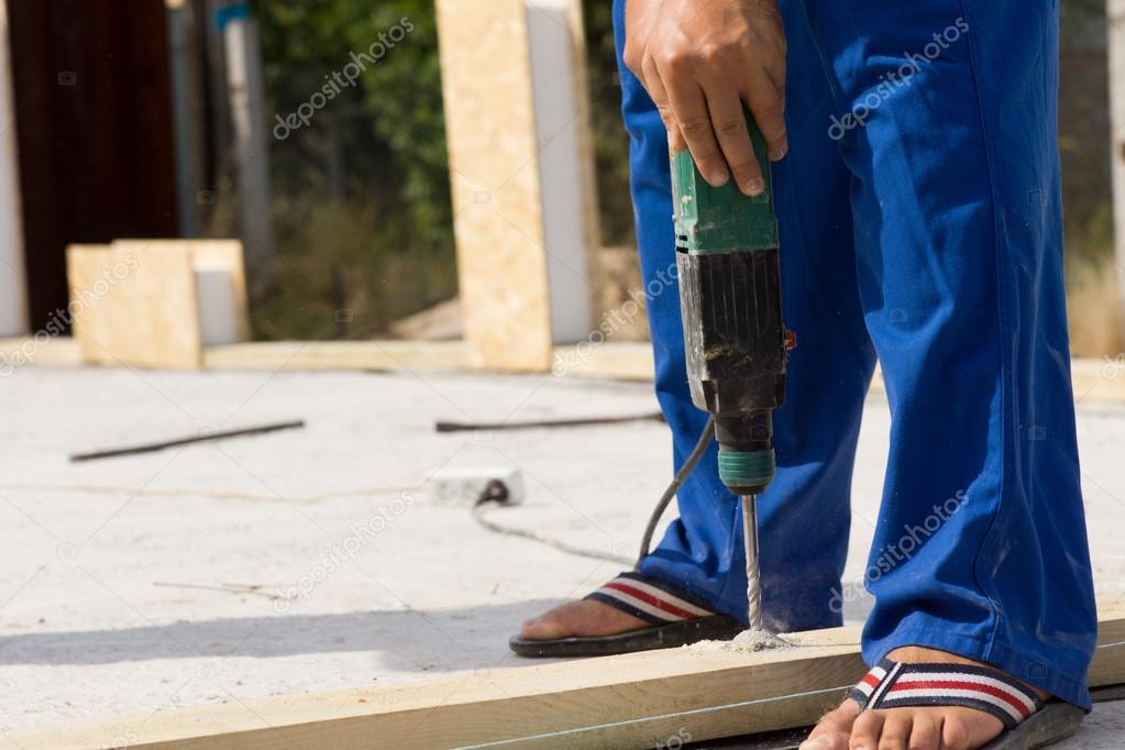 Construction Worker Drilling a Wood at Site Stock Photo by ©Vaicheslav ...