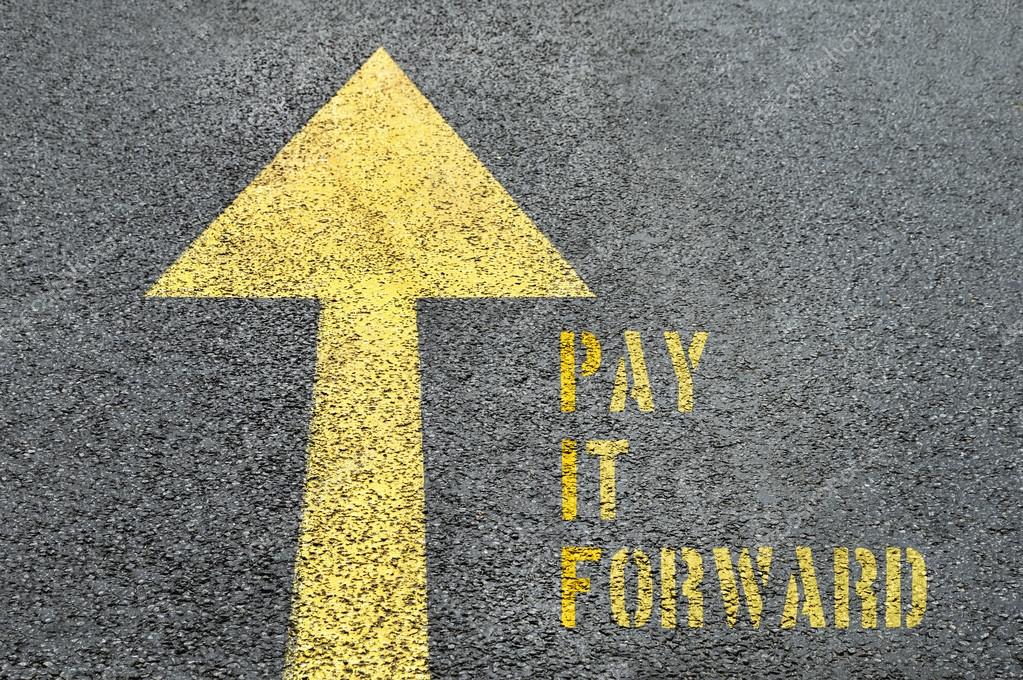Yellow forward road sign with Pay It Forward word on the asphalt ...