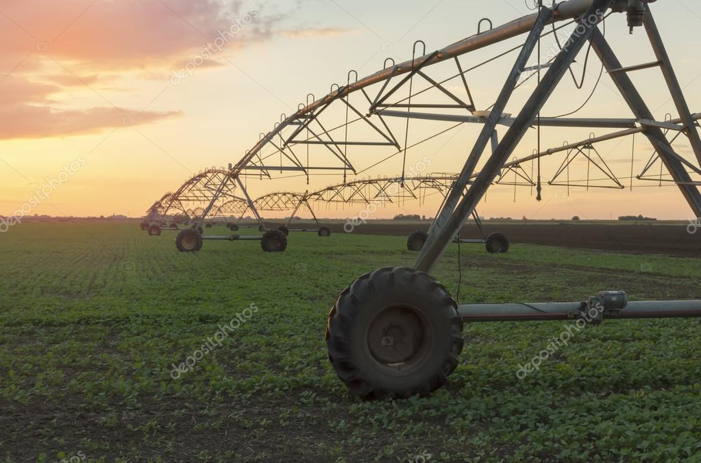 Modern irrigation system on a farm field at sunset. Stock Photo by ...