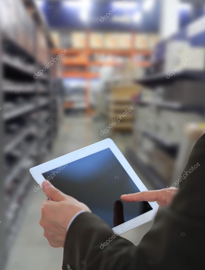 Businessman checking inventory in market on tablet computer — Stock ...