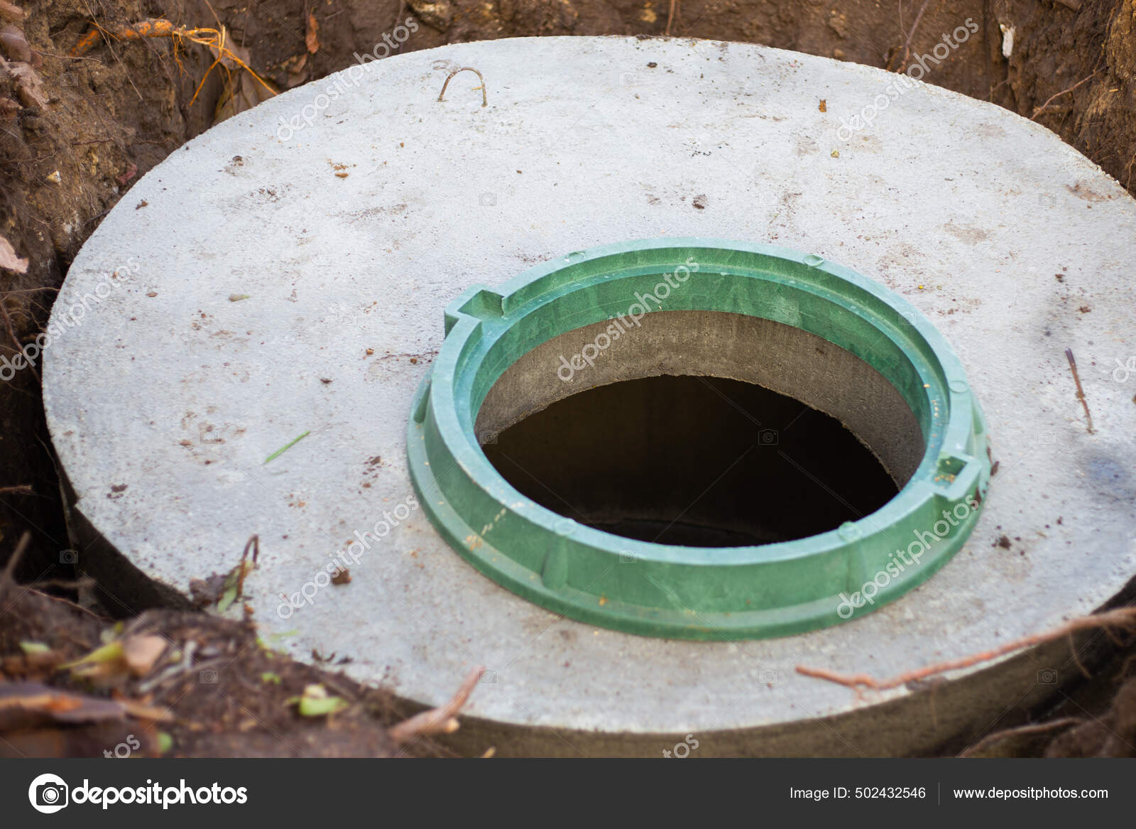 Construction of a septic tank. Large concrete rings embedded in the ...