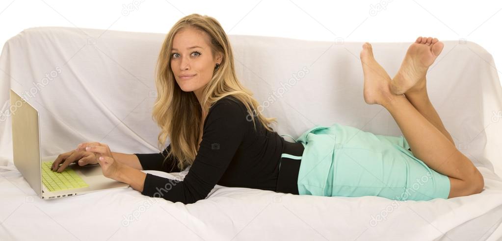 Woman lying on sofa with laptop — Stock Photo © alanpoulson #93370058
