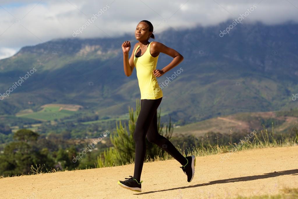 Fit young african woman jogging outdoors Stock Photo by ©mimagephotos ...