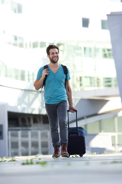 Cool guy walking with suitcase and bag - Stock Image - Everypixel