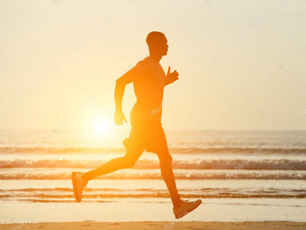 One man running on beach with sunset Stock Photo by ©mimagephotos 54967857