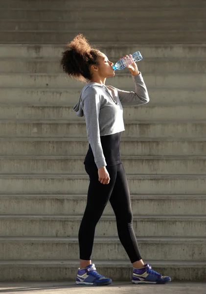 Female runner drinking from water bottle - Stock Image - Everypixel