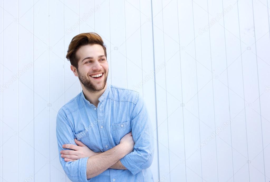 Attractive young man laughing with arms crossed — Stock Photo ...