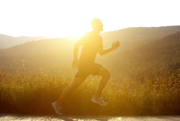 Man running outside with sunset - Stock Image - Everypixel