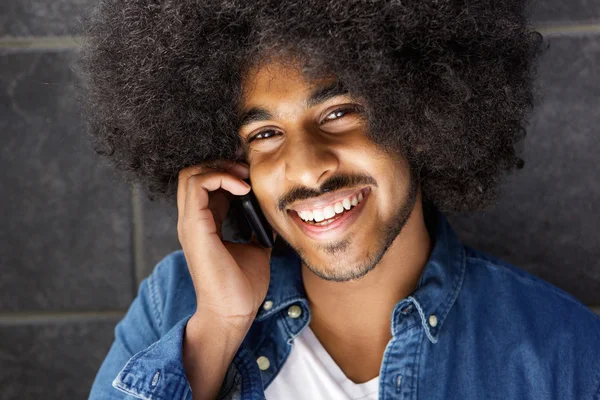 Cheerful black guy using cell phone - Stock Image - Everypixel