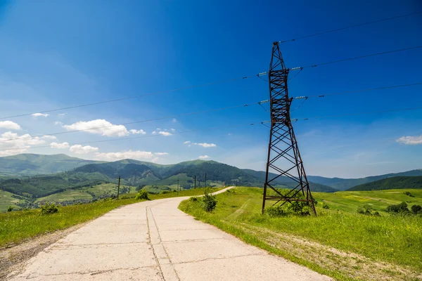 High voltage power lines tower in mountains Stock Photo by ©pellinni ...