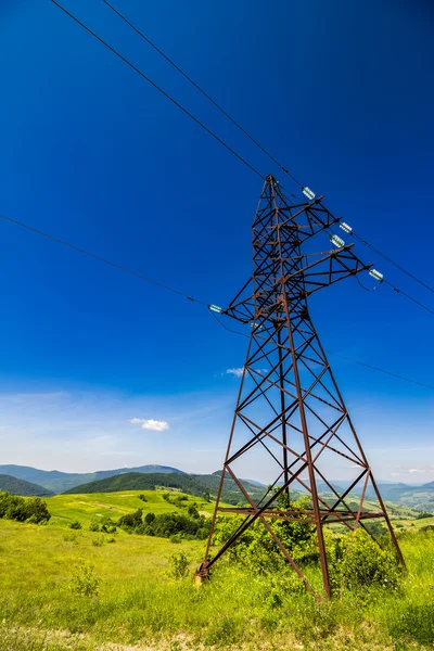 High voltage power lines tower in mountains Stock Photo by ©pellinni ...