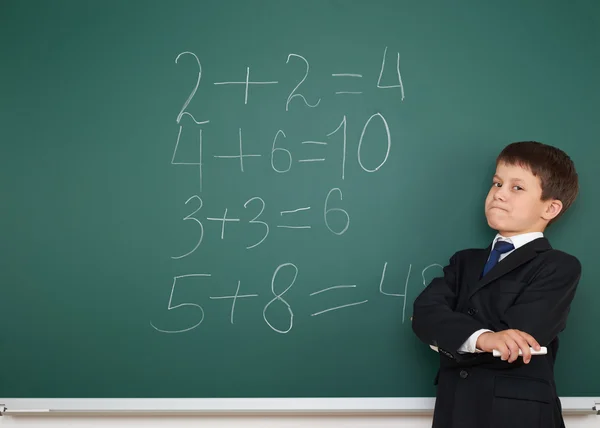 School boy solve math on board Stock Photo by ©soleg 82027334