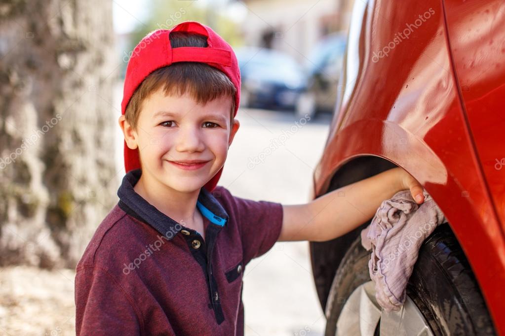Little boy cleaning red car Stock Photo by ©sakkmesterke 71447219