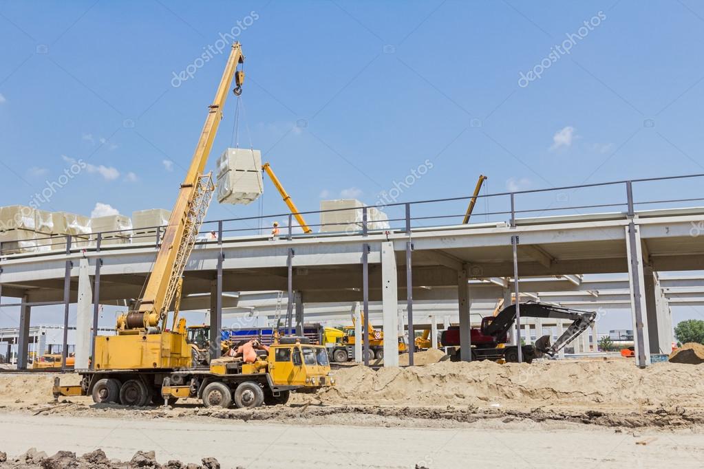 Mobile crane is raising package of glass wool on the roof huge u Stock ...