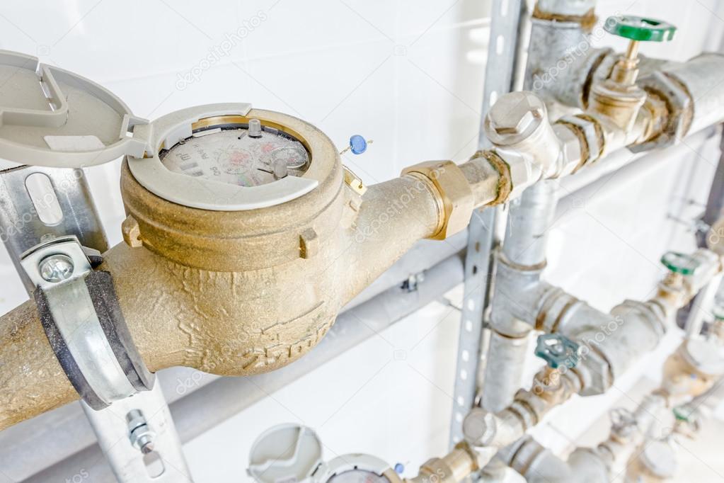 Room with lined up water meters, pipes and valves — Stock Photo ...